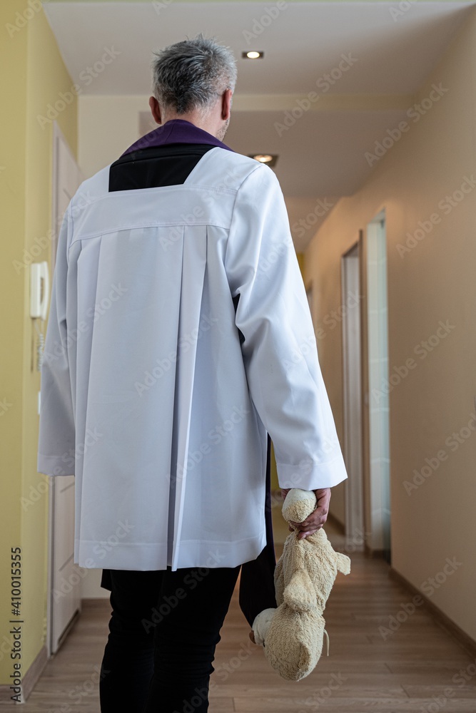 Catholic priest holding child plush toy teddy bear Stock Photo | Adobe ...