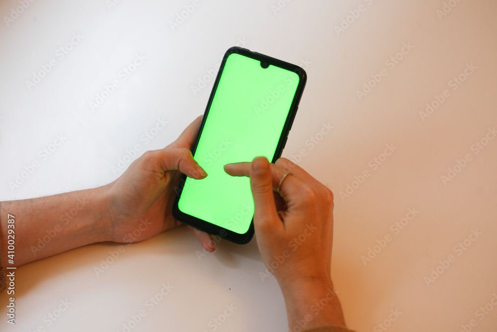 young girl pressing green screen of mobile phone with fingers Stock ...