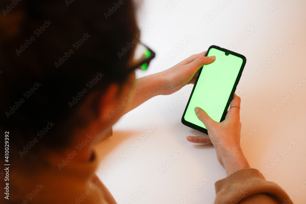 young girl pressing green screen of mobile phone with fingers Stock ...