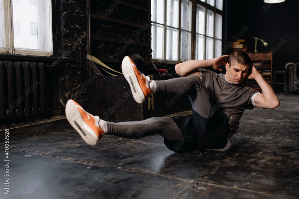 Cool man fighter in boxing bandages trains in the gym. Mixed martial ...