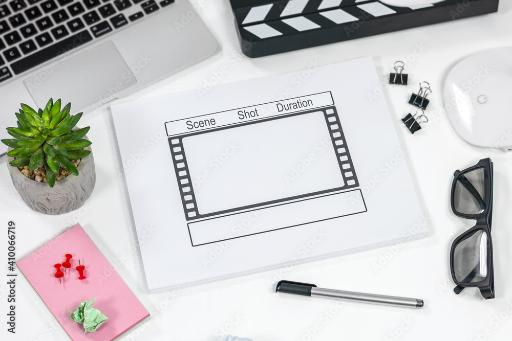 Screenwriter desktop with movie clapper board white table background ...