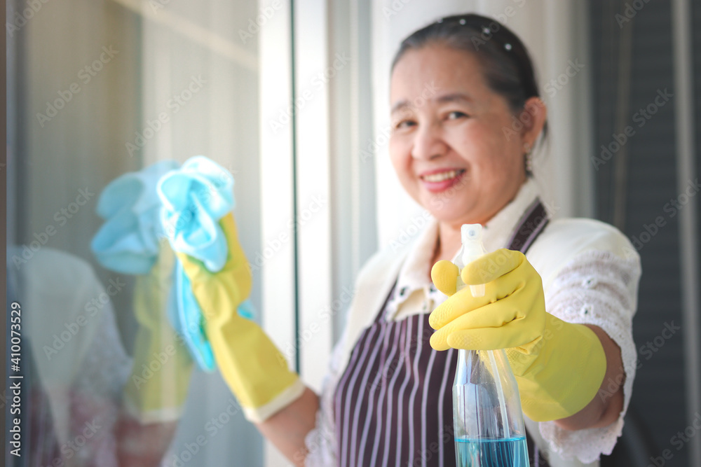Happy smiling Asian senior elderly woman housewife wearing rubber ...