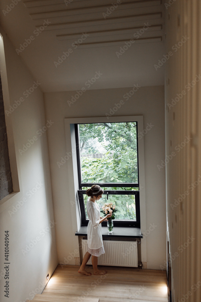 lovely bride in a wedding robe is going to the wedding. a hoop on the ...