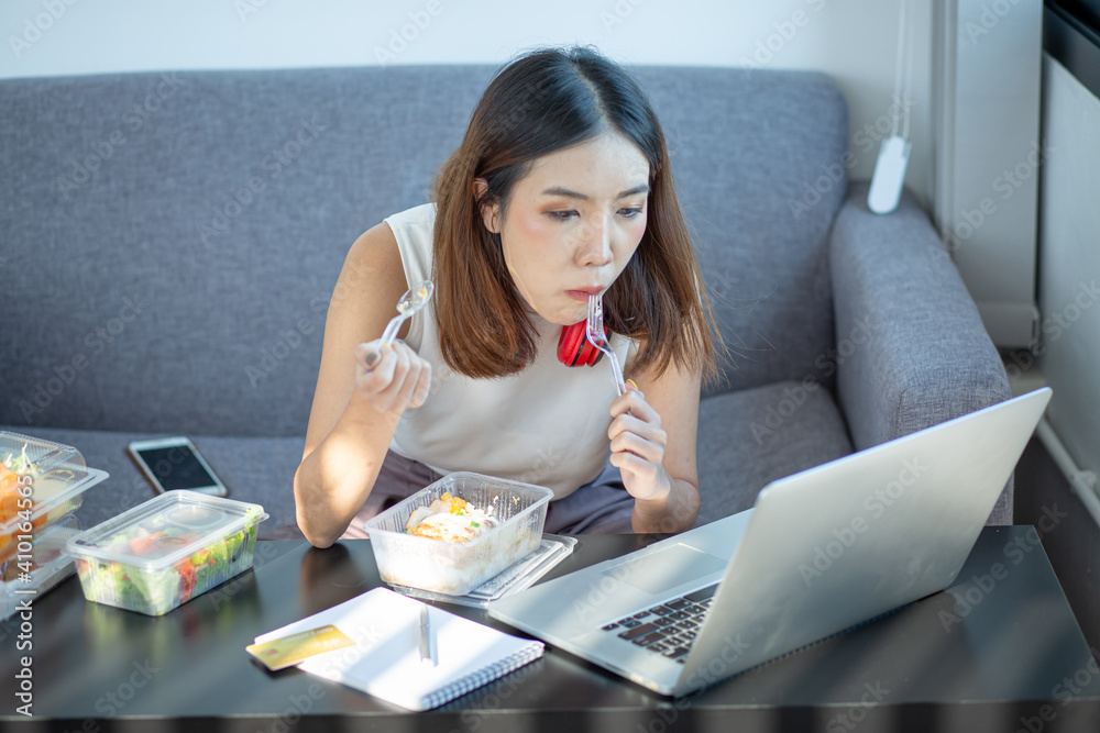 Young attractive asian female hungry eat doughnut take away snack food with full mouth look at ...