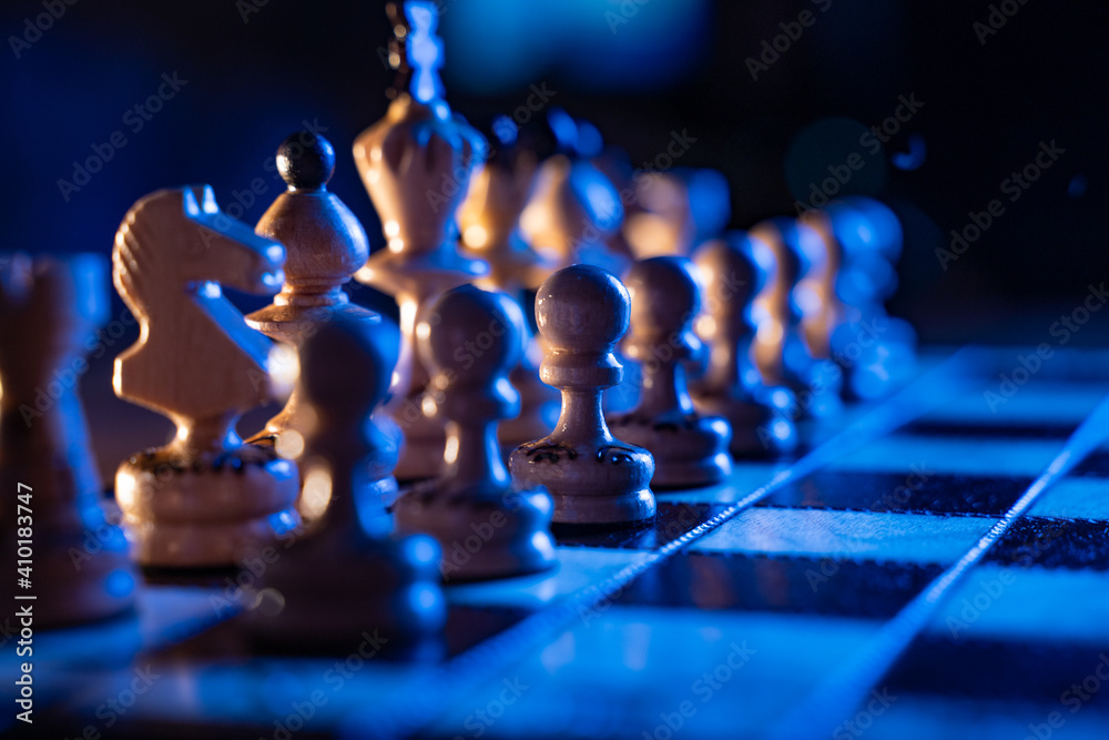 Foto Stock Chess board with chess pieces on blue background. Concept of ...