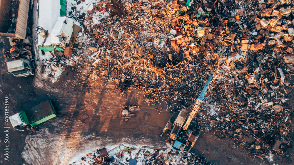 Aerial photography of a metal dump, A crane unloads, loads metal waste ...