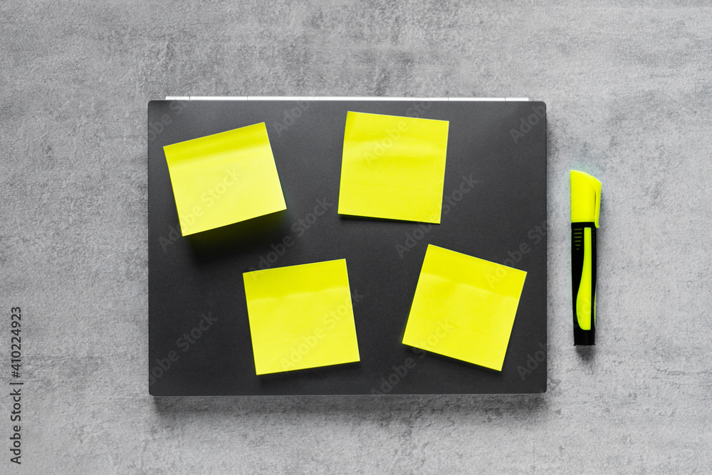 Yellow stickers on a gray laptop. Workplace. A study table. Remote work ...