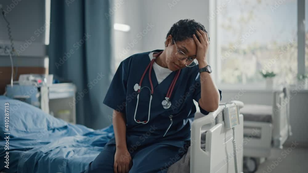 Hospital Ward: Portrait of Sad, Tired Black Nurse Sitting on a Bed ...
