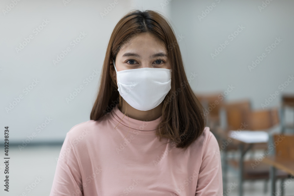 Group of college students wearing a face mask and keep distance while ...