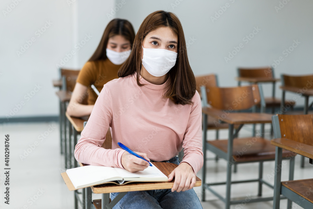 Group of college students wearing a face mask and keep distance while ...