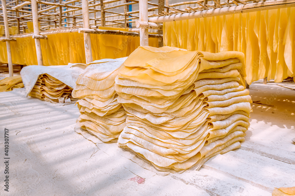 The farmer making rubber sheets hang on bamboo process dry by solar ...