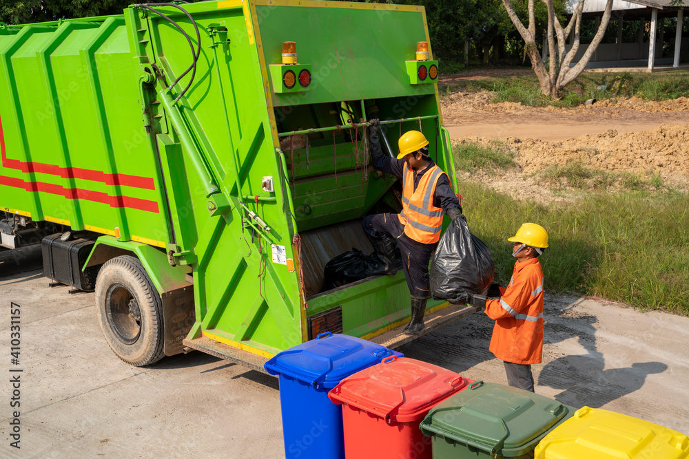 Garbage man working together on emptying dustbins for trash removal ...