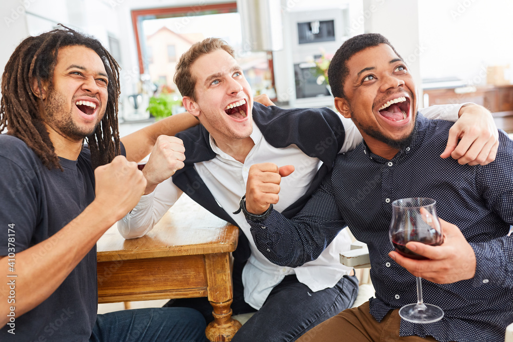 Men as friends cheer together while watching football or sports Stock ...