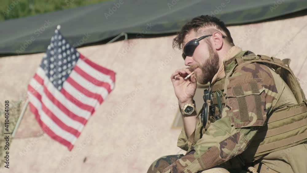 Tilting-up footage of brutal US army officer in camouflage uniform ...