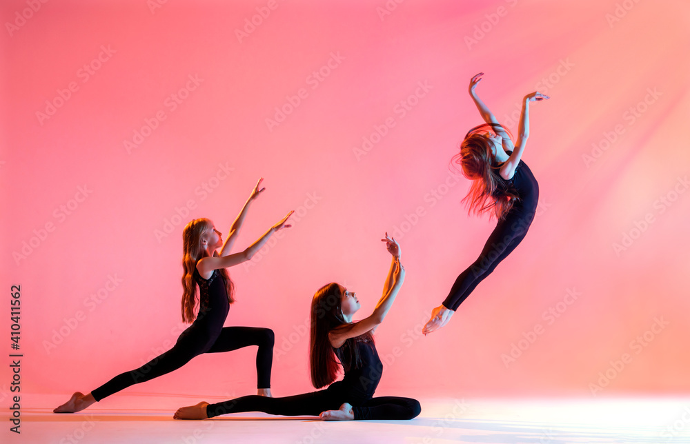 group of three ballet girls with long flowing hair in black tight ...