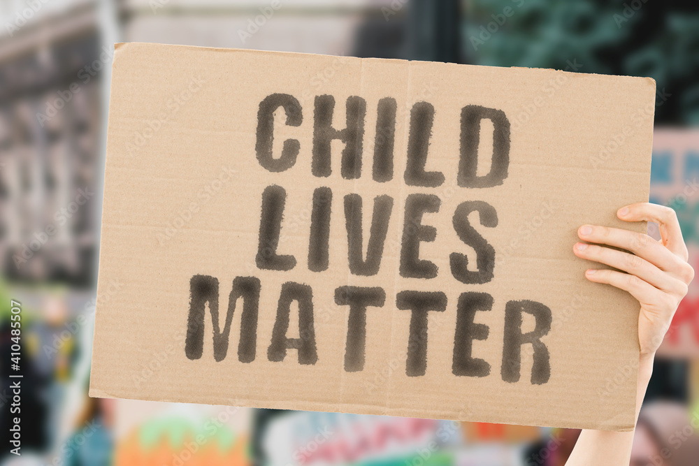 The question " Child lives matter " on a banner in hand with blurred ...