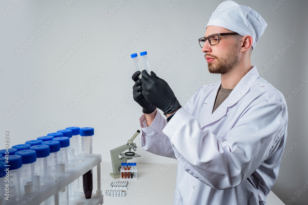 Virologist holds empty test tubes. A man in a doctor's uniform. Concept ...