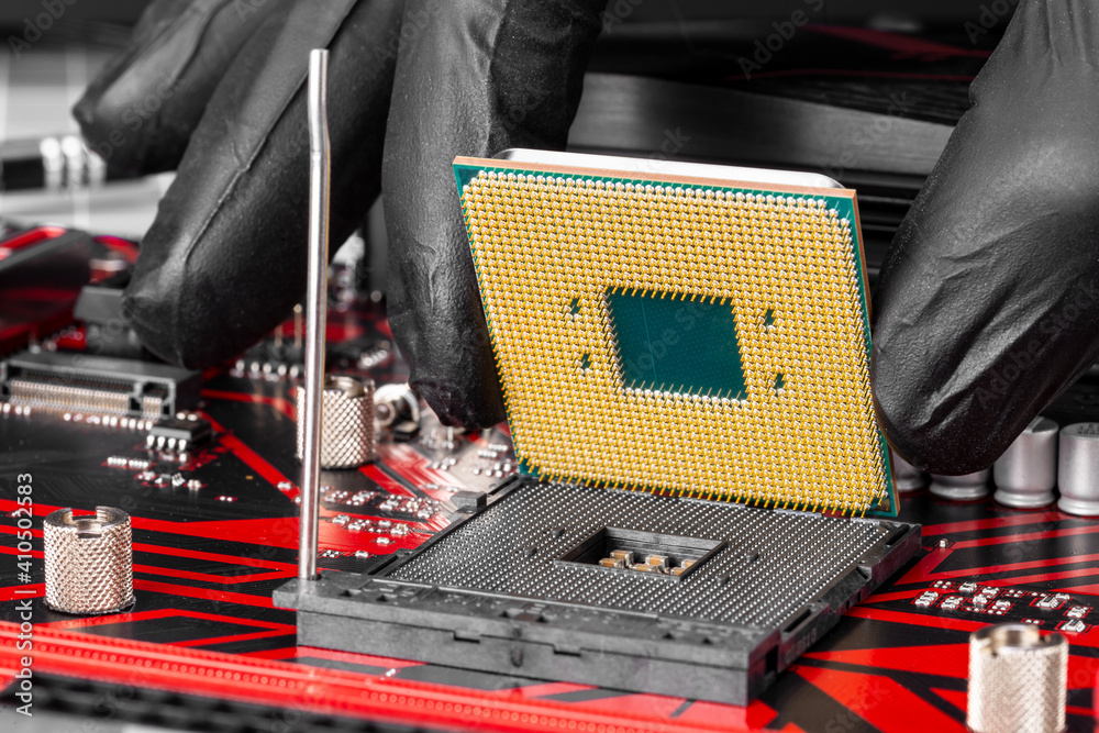 Hand With Cpu At Installation Of A Computer Processor Into Socket