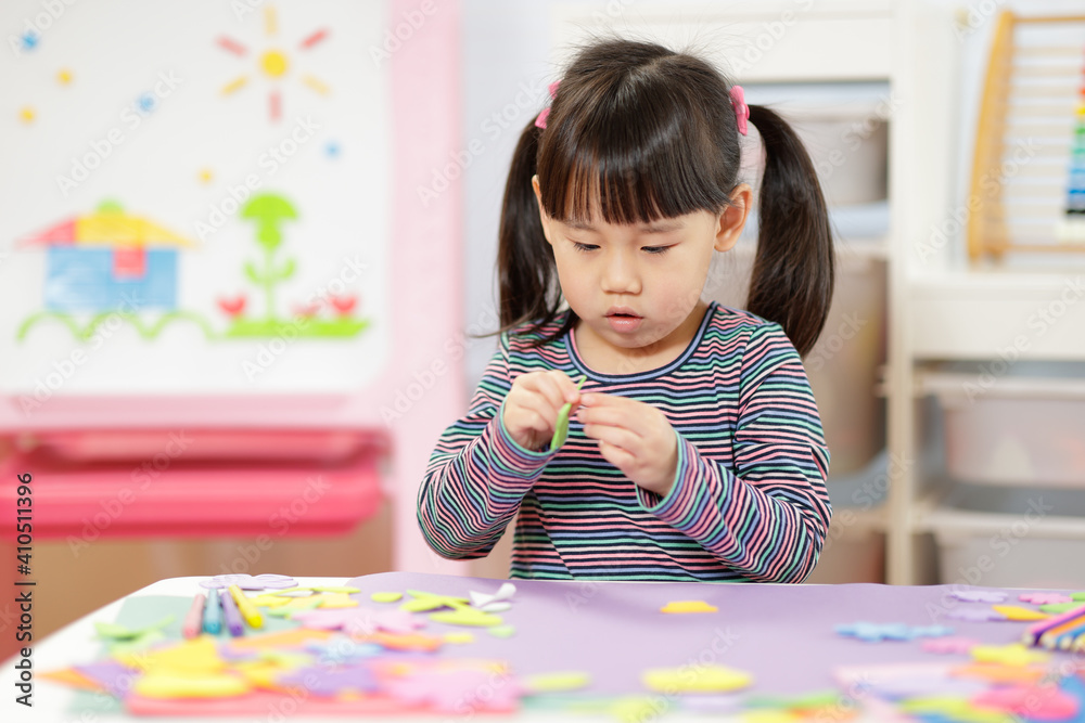 young girl making craft for homeschooling Stock Photo | Adobe Stock