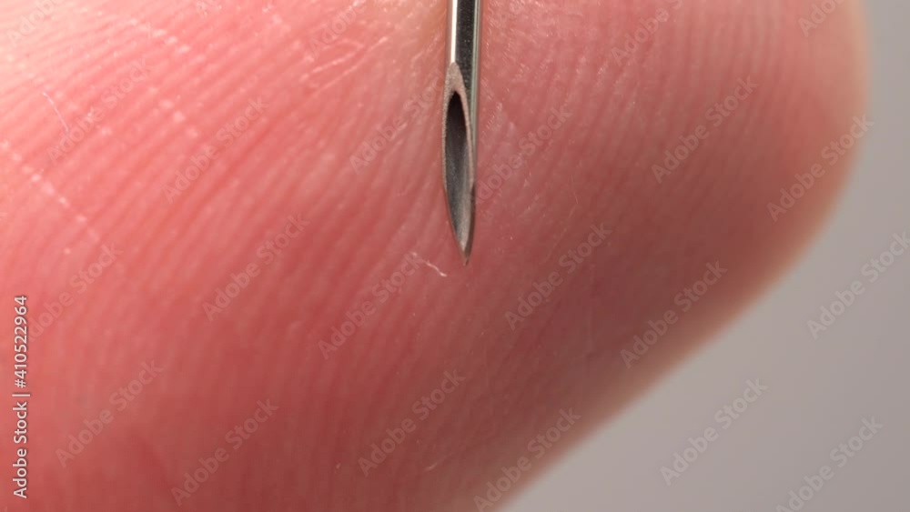 Finger touching medical syringe needle. Macro close up. Trypanophobia ... Finger touching medical syringe needle. Macro close up. Trypanophobia ...