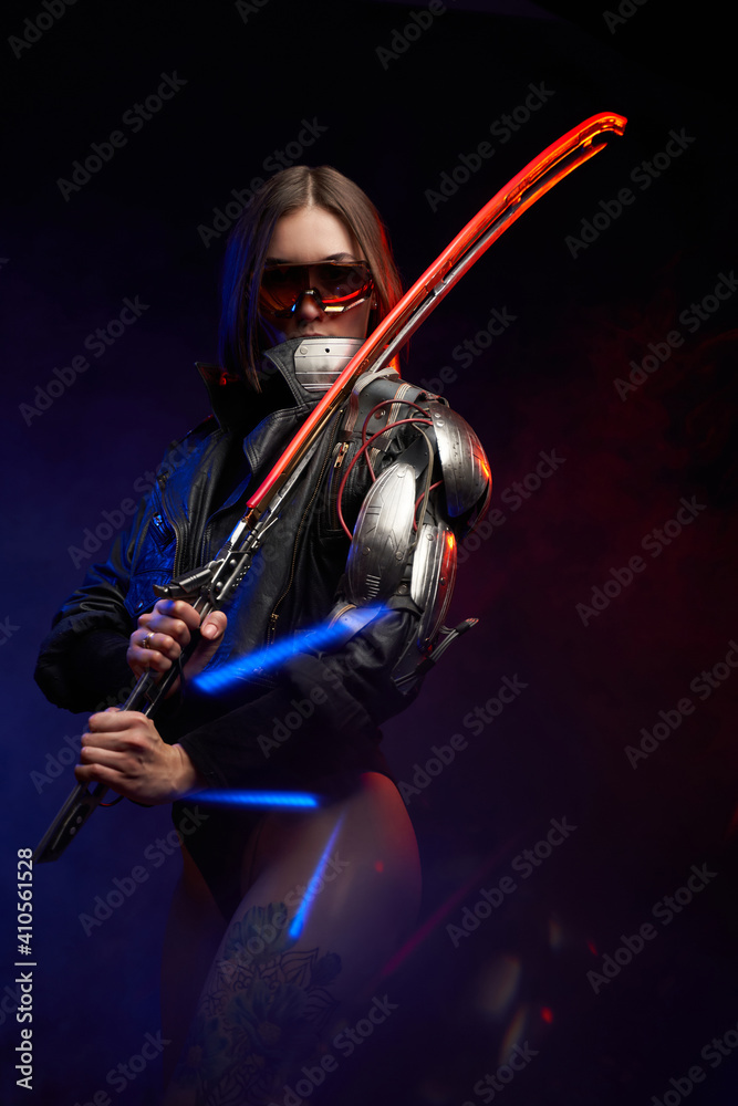 Atmospheric portrait of a beautiful female assassin posing in dark ...