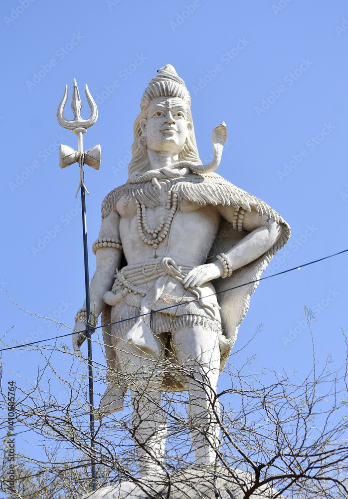 Vertical closeup of the statue of Lord Shiva against a blue sky Stock ...