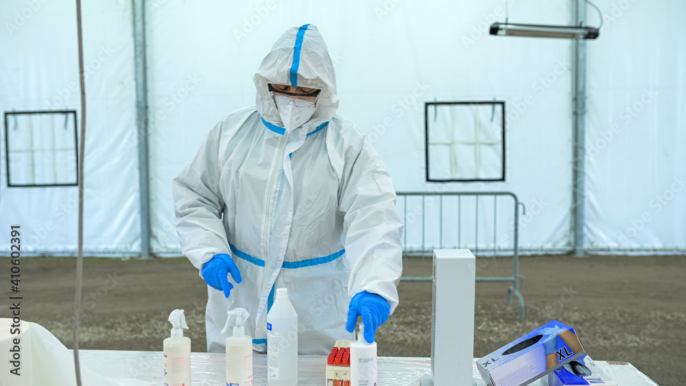 Unrecognizable nurse man with personal protective equipments and suit ...