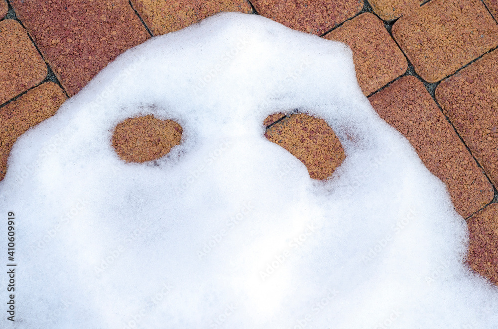 The snow on the paving slabs melted into the shape of a ghost. The ...