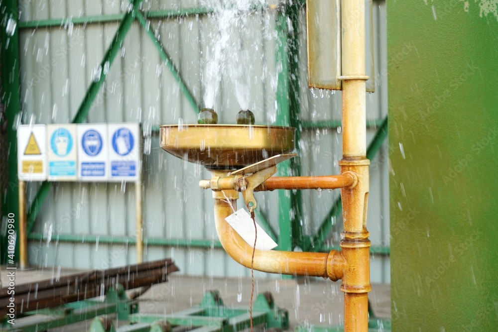 Activating eye wash station for emergency use at construction site in a ...