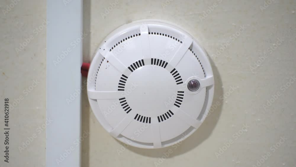 Red flashing light on the sensor of the fire safety system in the room ...