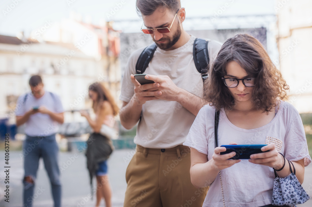 Group of friends using smartphones together. Young people addiction to ...