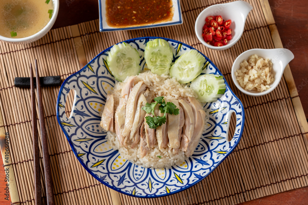 Closed up Chinese chicken rice that serve soup and spicy source, on ...