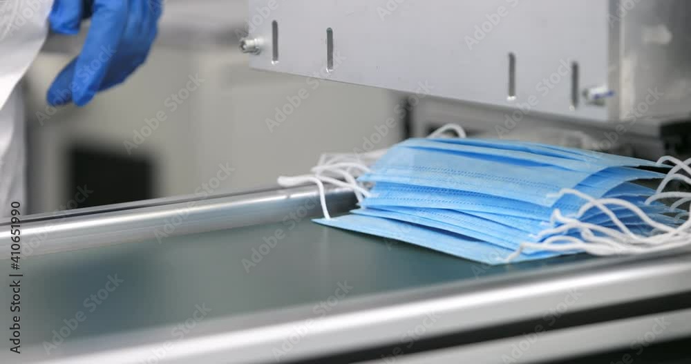 Covid protection. Manufacture of surgery masks. Medical mask on ...