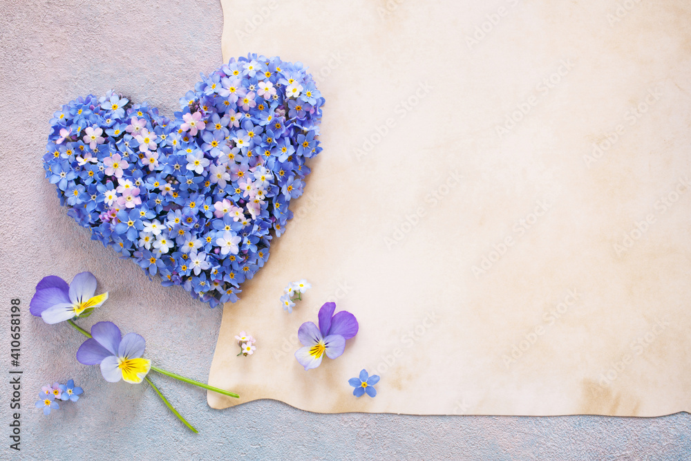 Forget-me-not flowers in the shape of a heart and violets, pansies and ...