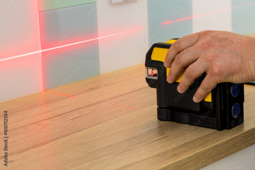 Electronic laser pointing straight lines. Checking angles and setting ...