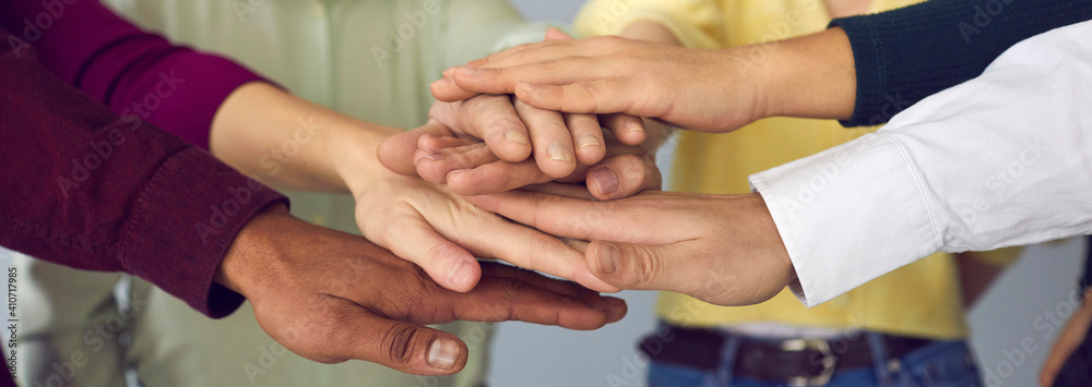 Foto de Close up of a group of international people folding their arms ...