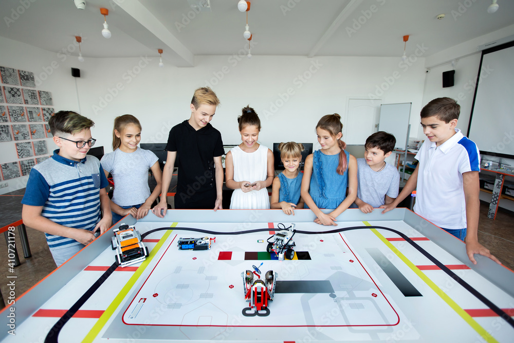 Robotics competitions. A group of children assembled robots from ...
