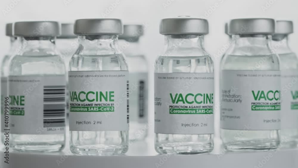 Looped. Flasks of vaccine for COVID-19 coronavirus cure are slowly rotated in research lab ...