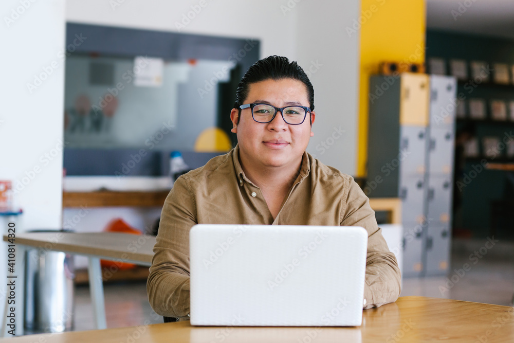 plus size latin man working on laptop in office in Mexico city Stock ...
