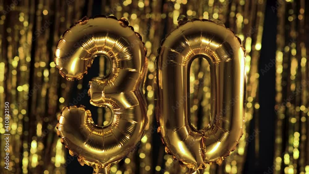 The golden number 30 thirty is made from an inflatable balloon on a ...