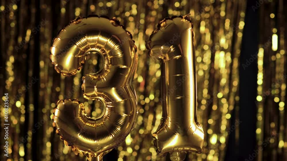 The golden number 31 thirty one is made from an inflatable balloon on a ...