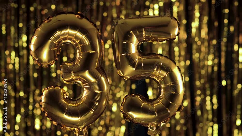 The golden number 35 thirty five is made from an inflatable balloon on ...