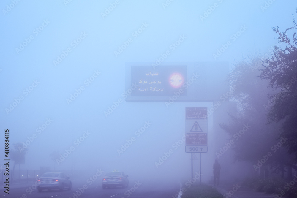 Road in the fog, sign mention keep distance for motorists at dubai road ...