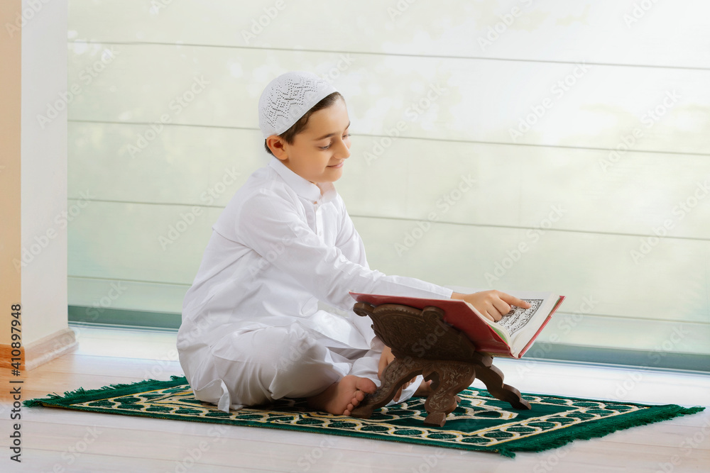 Muslim boy reading the Quran Stock Photo | Adobe Stock