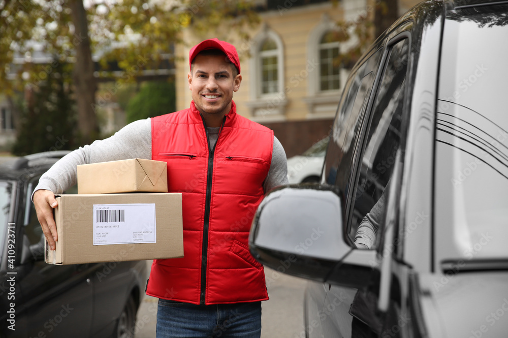Courier with parcels near delivery van outdoors Stock Photo | Adobe Stock