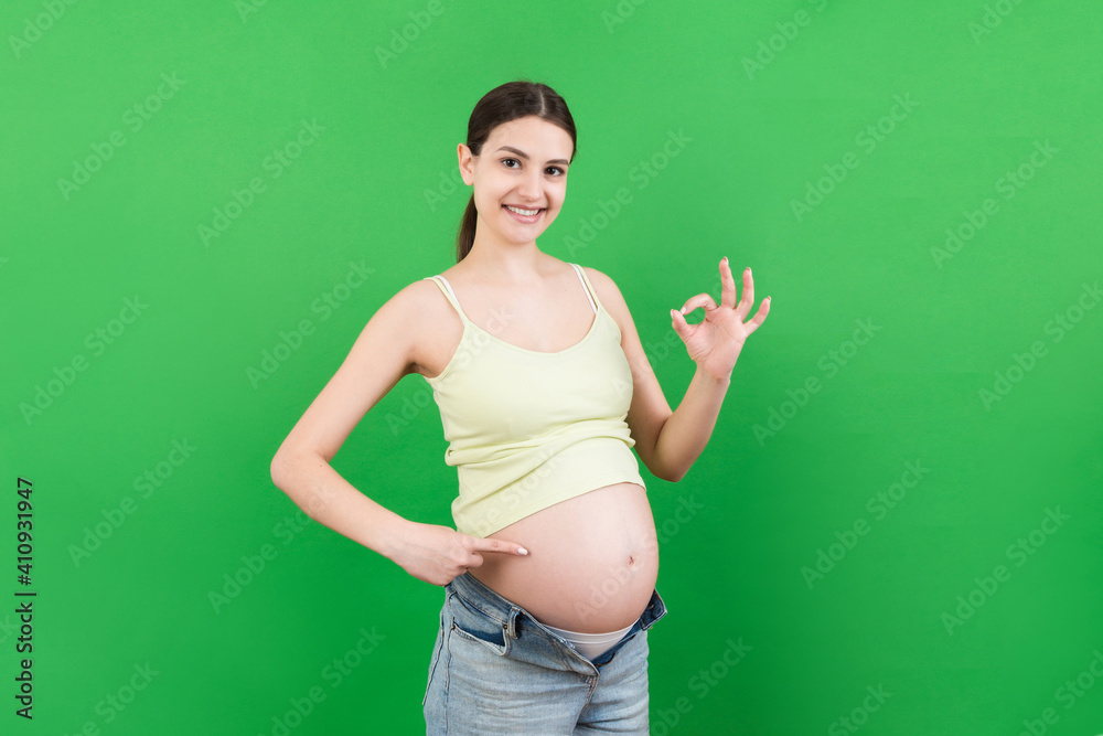 Young beautiful teenager girl pregnant expecting baby over isolated ...