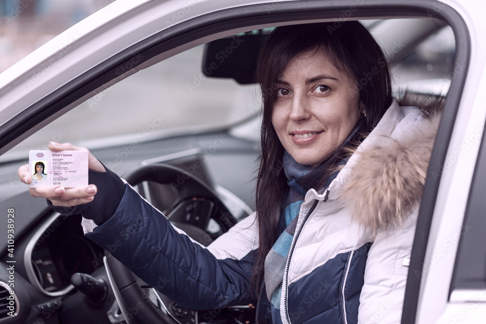 Getting a driver's license, female hands show US driving license, amid ...