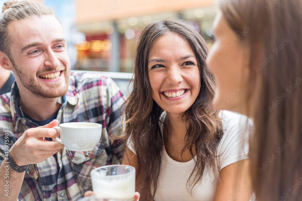 Multiracial group of friends having a coffee together - Two women and a ...