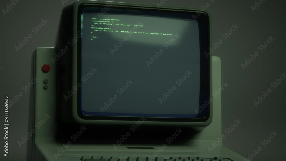 Retro personal computer or PC with source code displayed on monitor ...