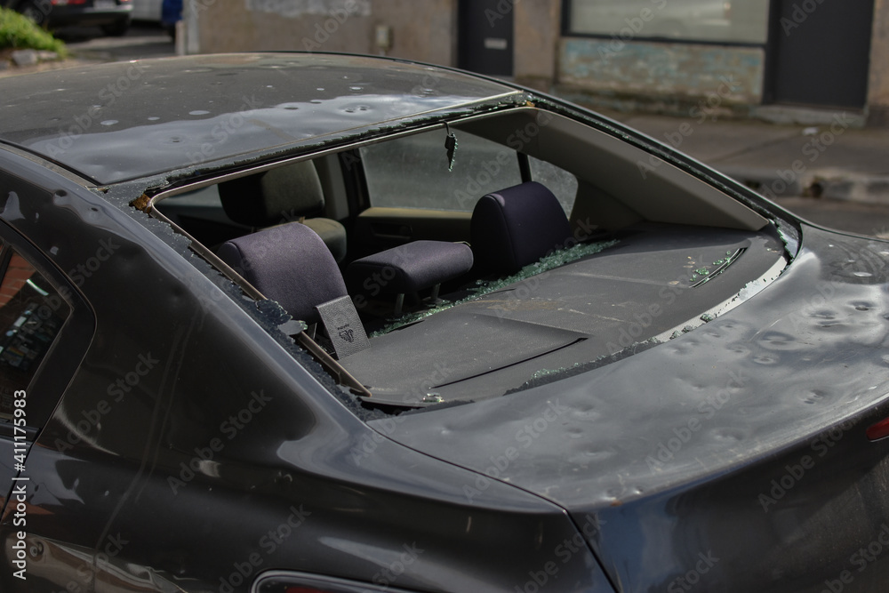 Damaged car with smashed rear window waiting repair at an auto panel ...